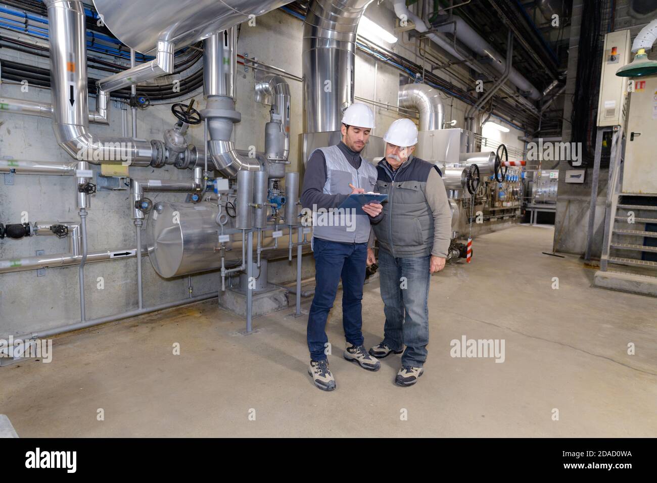 portrait of a factory engineers talking Stock Photo - Alamy