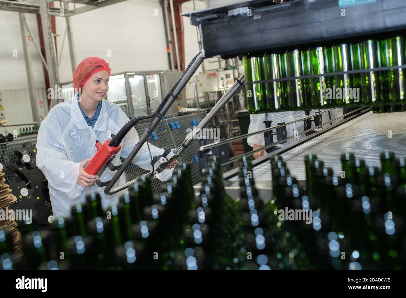 factory worker operating conveyor with plastic bottles Stock Photo - Alamy
