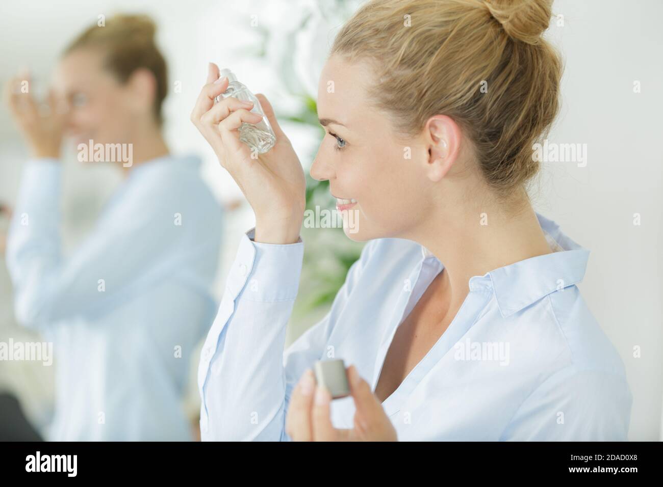 a woman smelling a perfume Stock Photo - Alamy