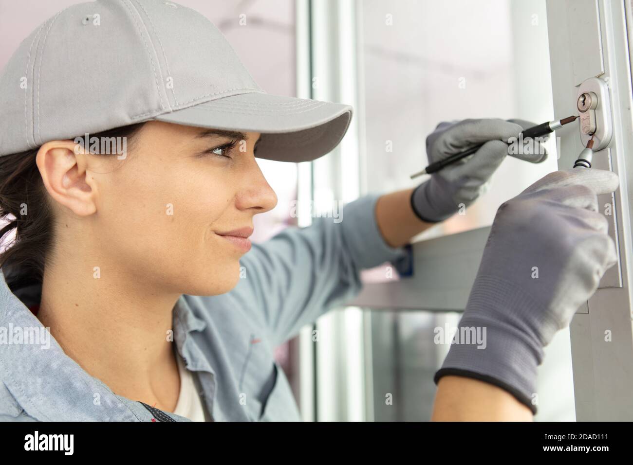 woman repairing a door lock Stock Photo - Alamy