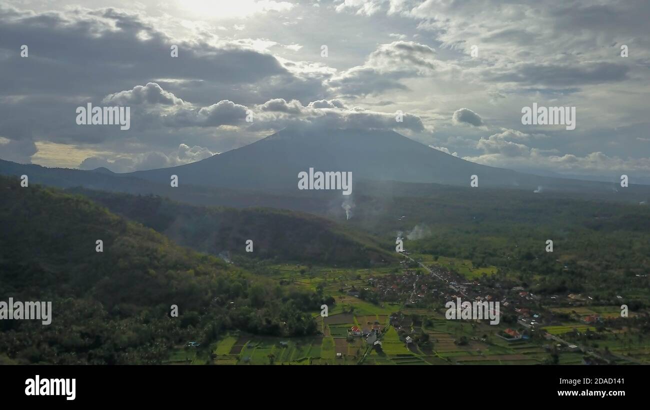 volcano with cloudy clear sky. Mount Merapi in Indonesia. Cloudy sky ...