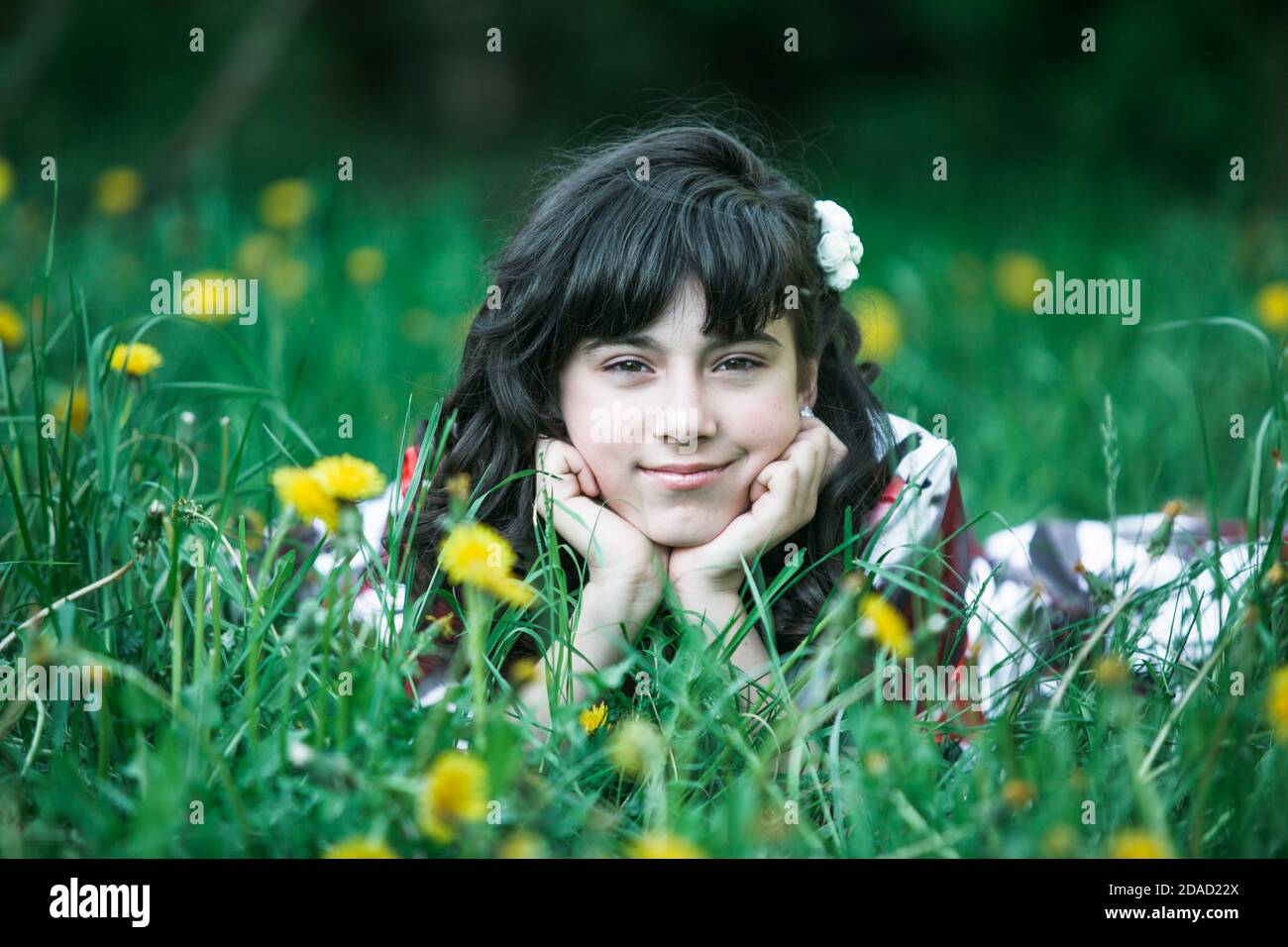Teen girl lying in the green grass in the park Stock Photo - Alamy