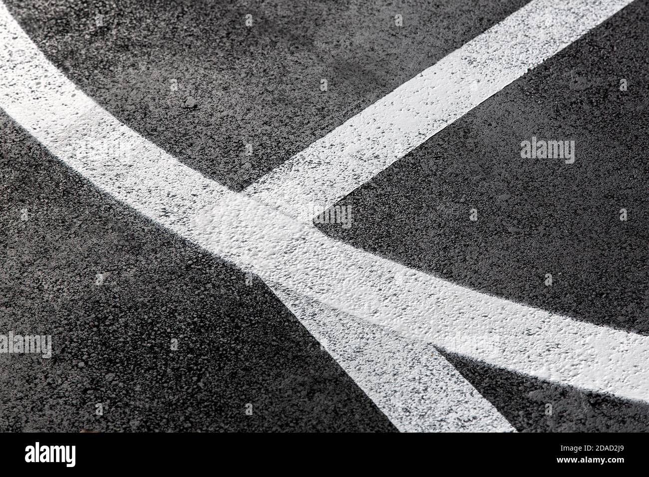 white lines marking the playing field on a bituminous surface, close up ...