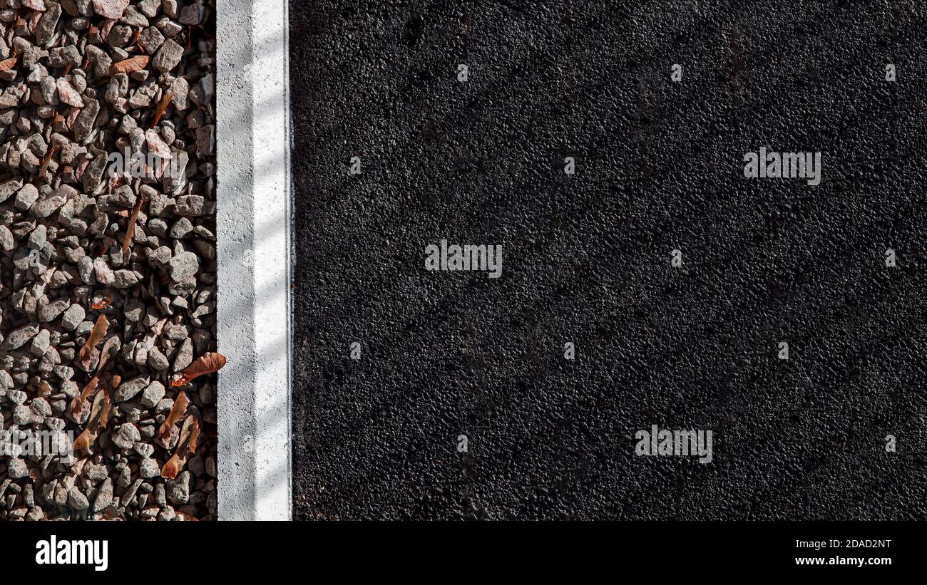 side of an asphalt bituminous road with a curb and mulching with ...