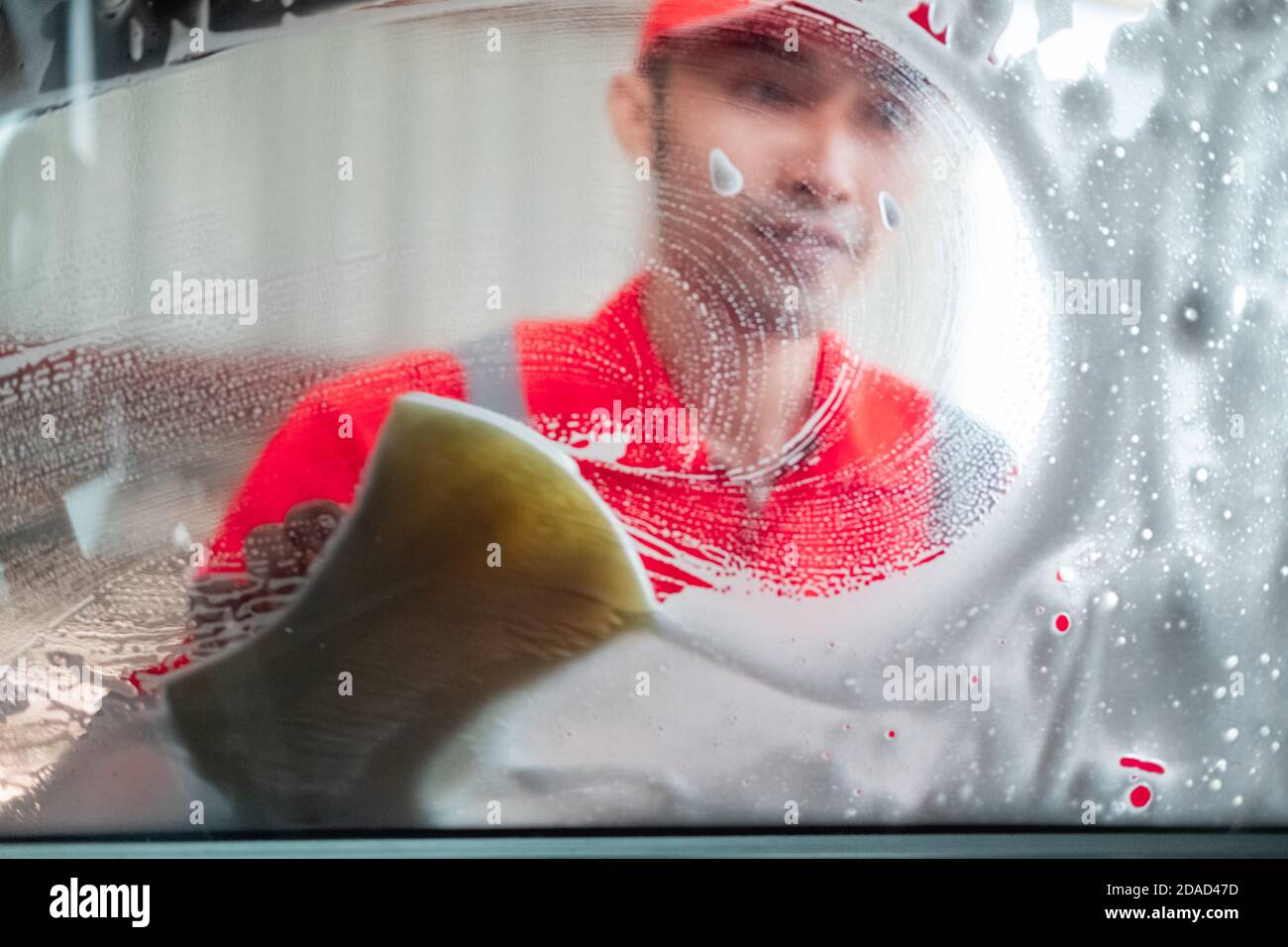 image photo from inside the car cleaning car Asian man wearing uniform ...