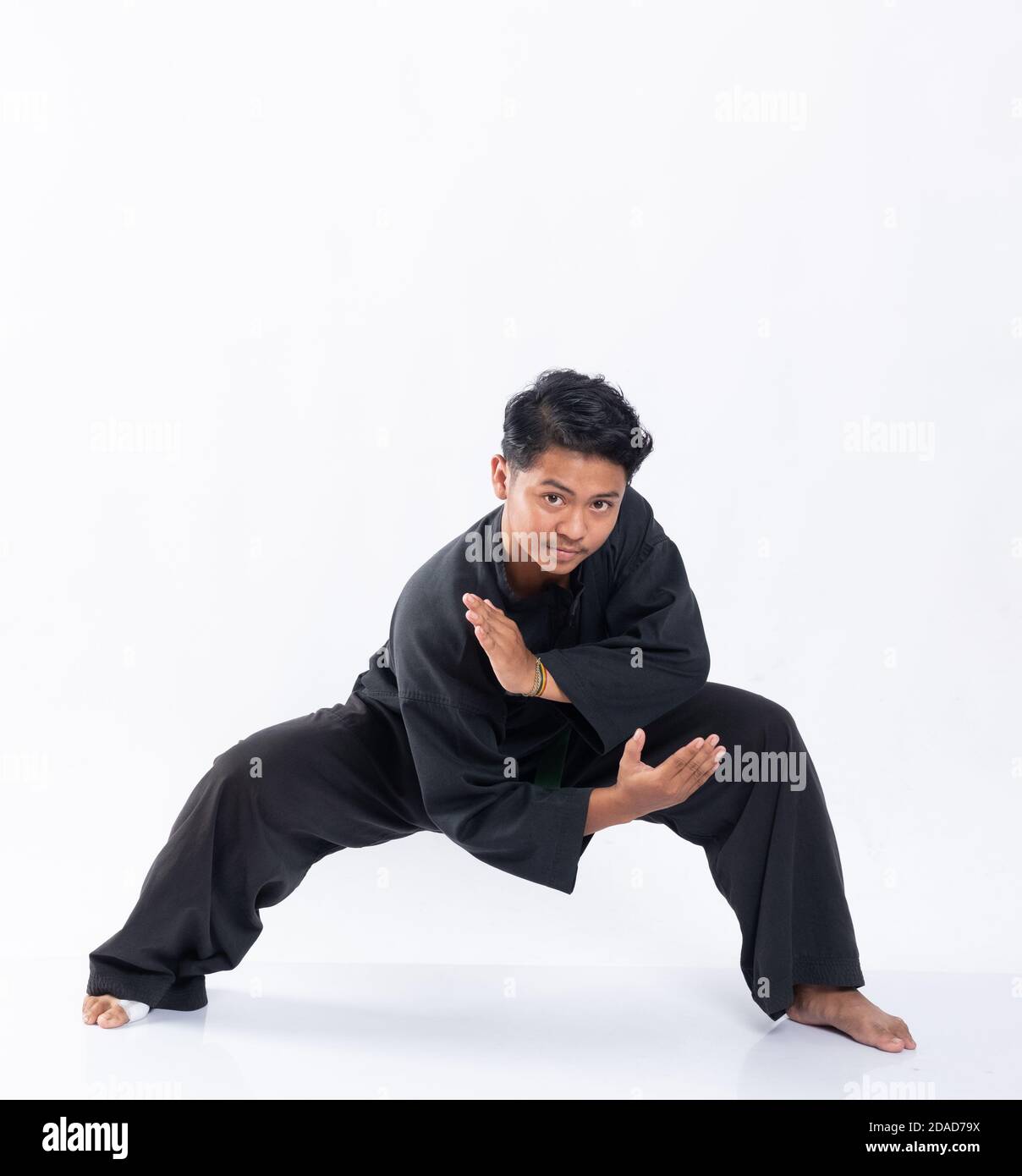 young man wear pencak silat sports uniforms to fight on a white ...