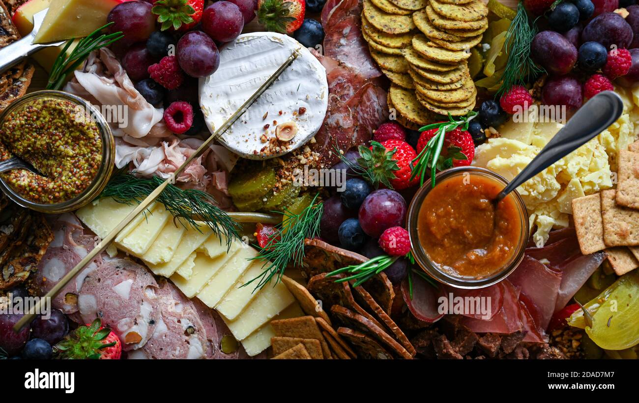 Charcuterie and cheese grazing board Stock Photo - Alamy