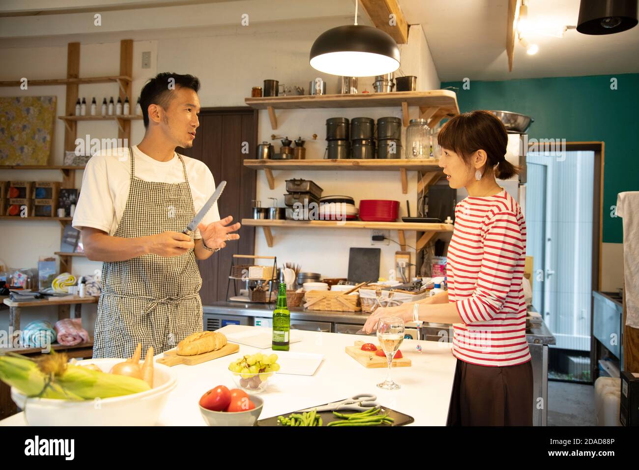 Man and Woman Cooking in the Shared Kitchen Stock Photo - Alamy