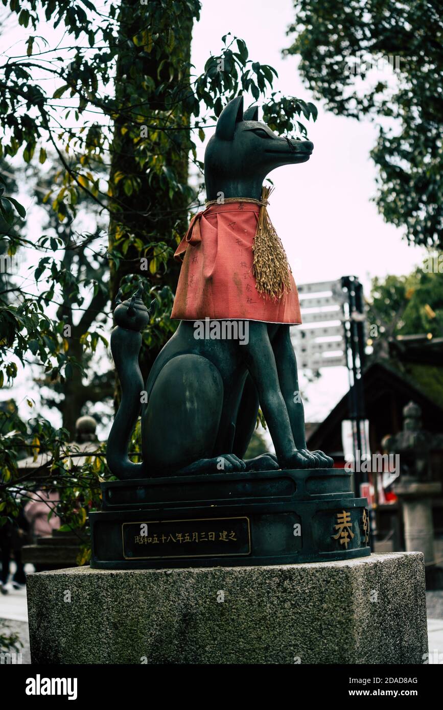 Fox sculpture with rice paddy and fish at Fushimi Inari Taisha Shrine ...