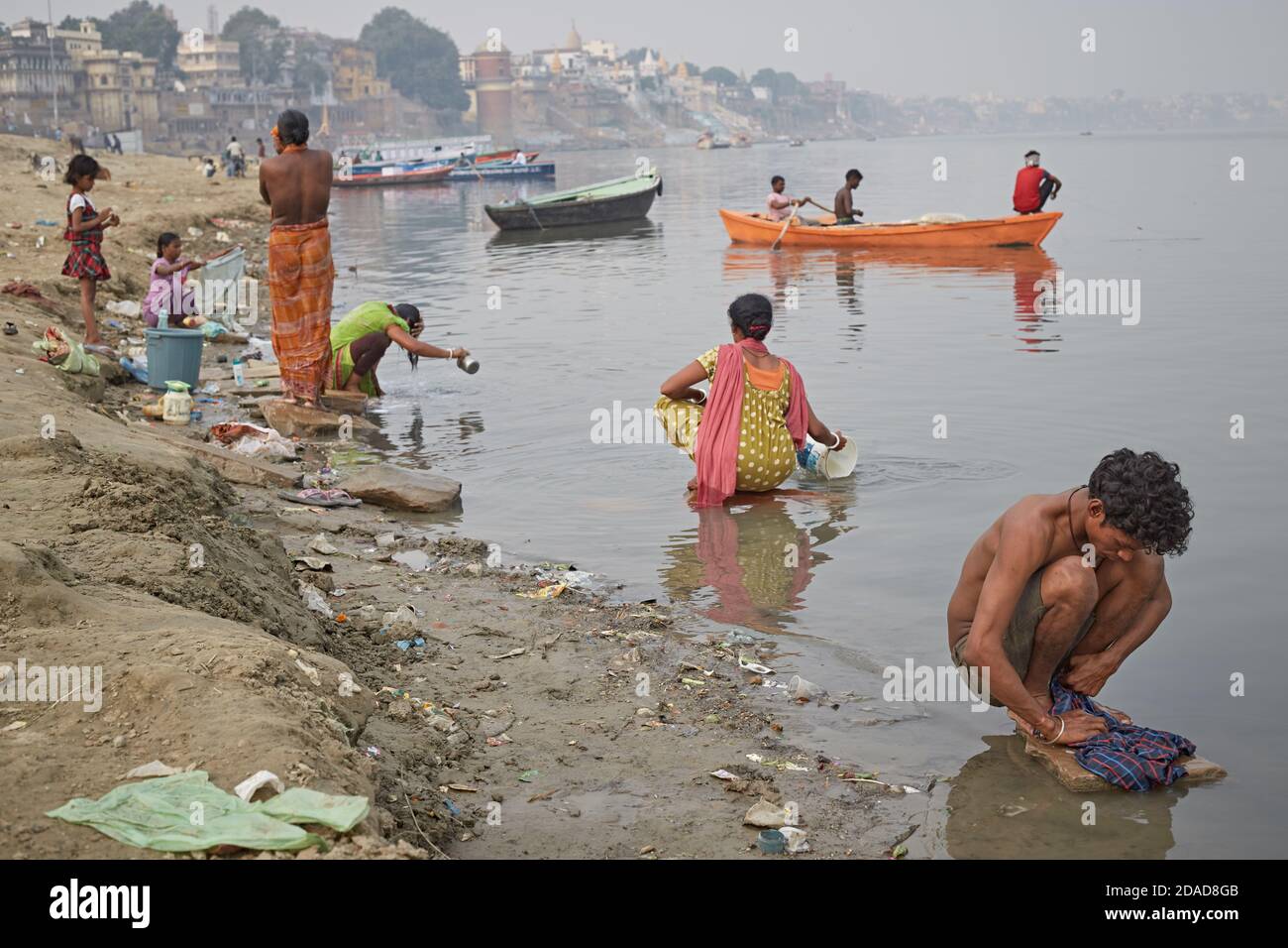 Varanasi, India, November 2015. People wash their clothes in a ghat on ...
