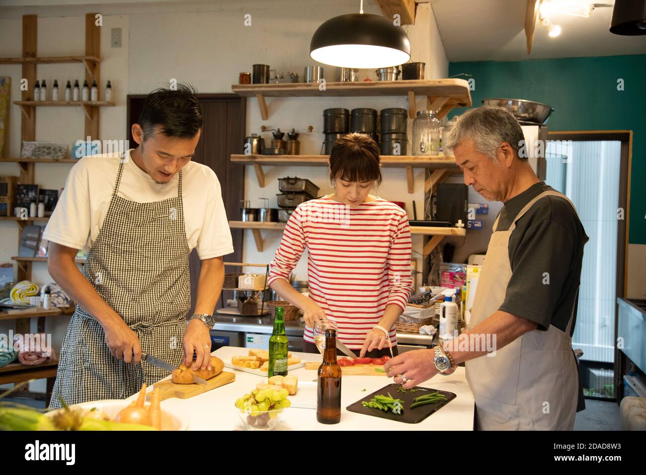 Men and Woman Cooking in the Shared Kitchen Stock Photo - Alamy