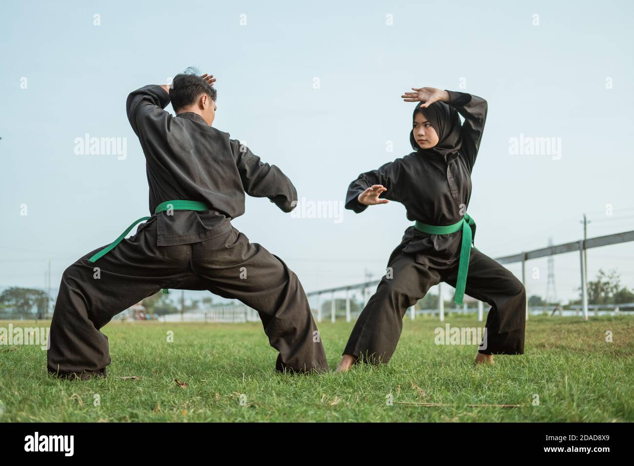 Asian male fighter wearing a pencak silat uniform with side stance ...