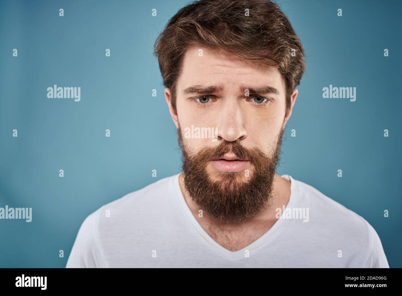 Bearded man displeased facial expression emotions close-up blue ...