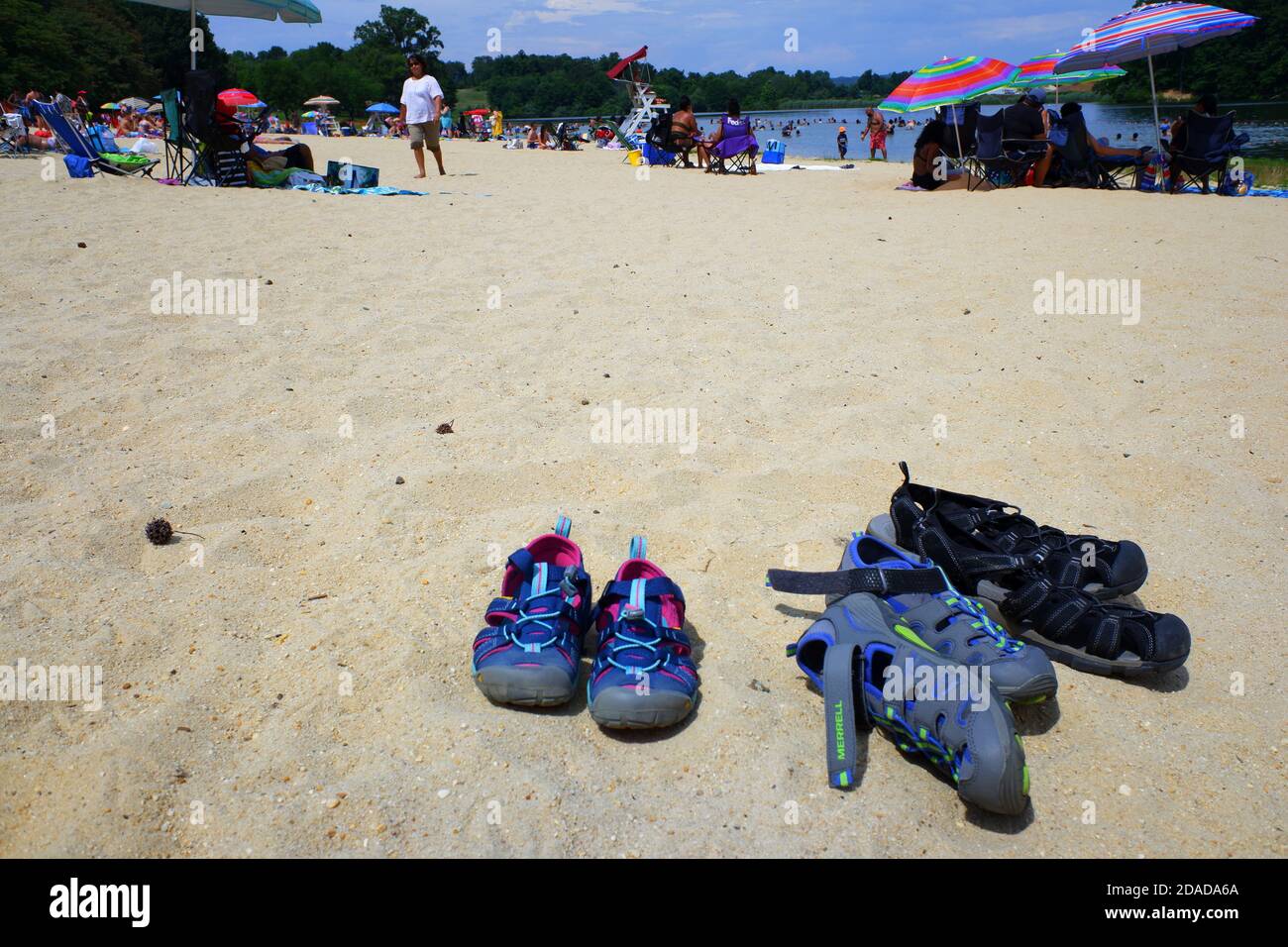Sandals on the beach of Round Valley Recreation Area with visitors in ...