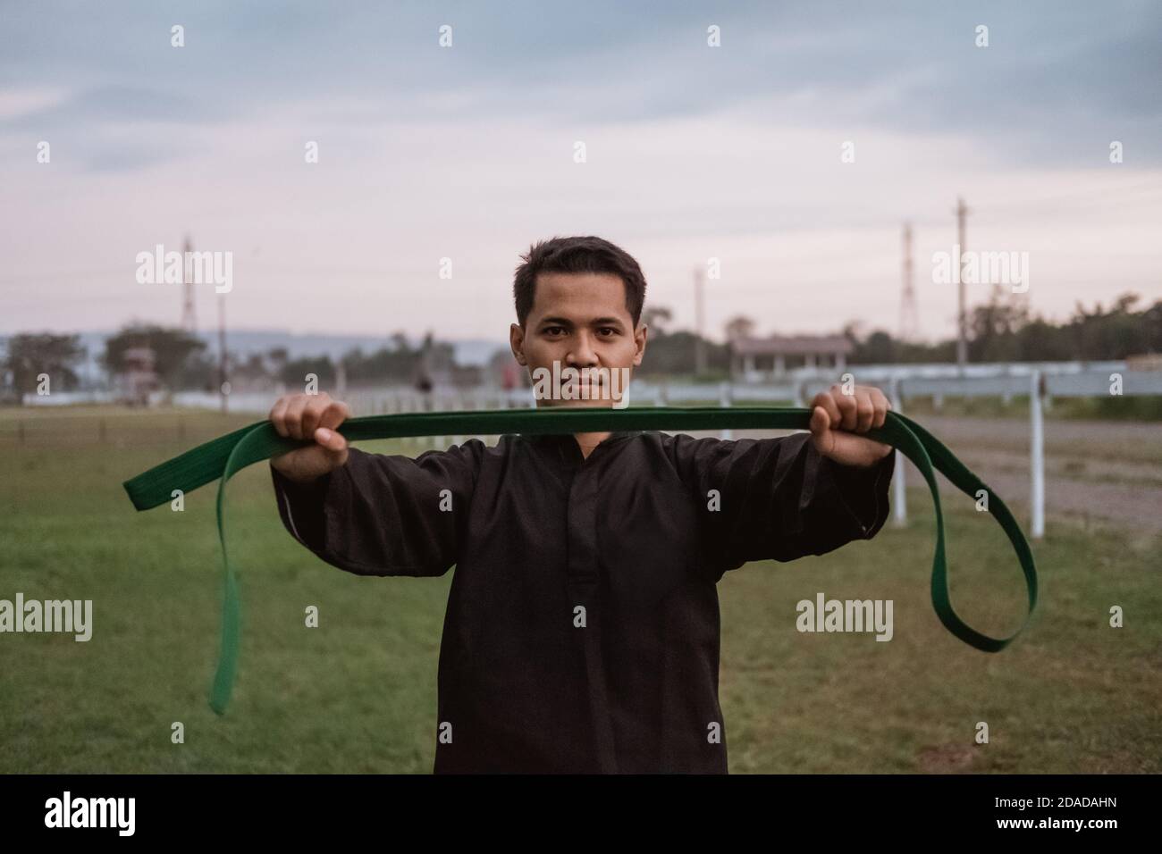 men wearing pencak silat uniforms with movements of both hands holding ...
