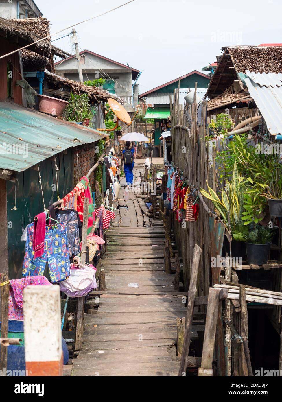 Wooden footbridge between houses at a residential area built on a swamp ...