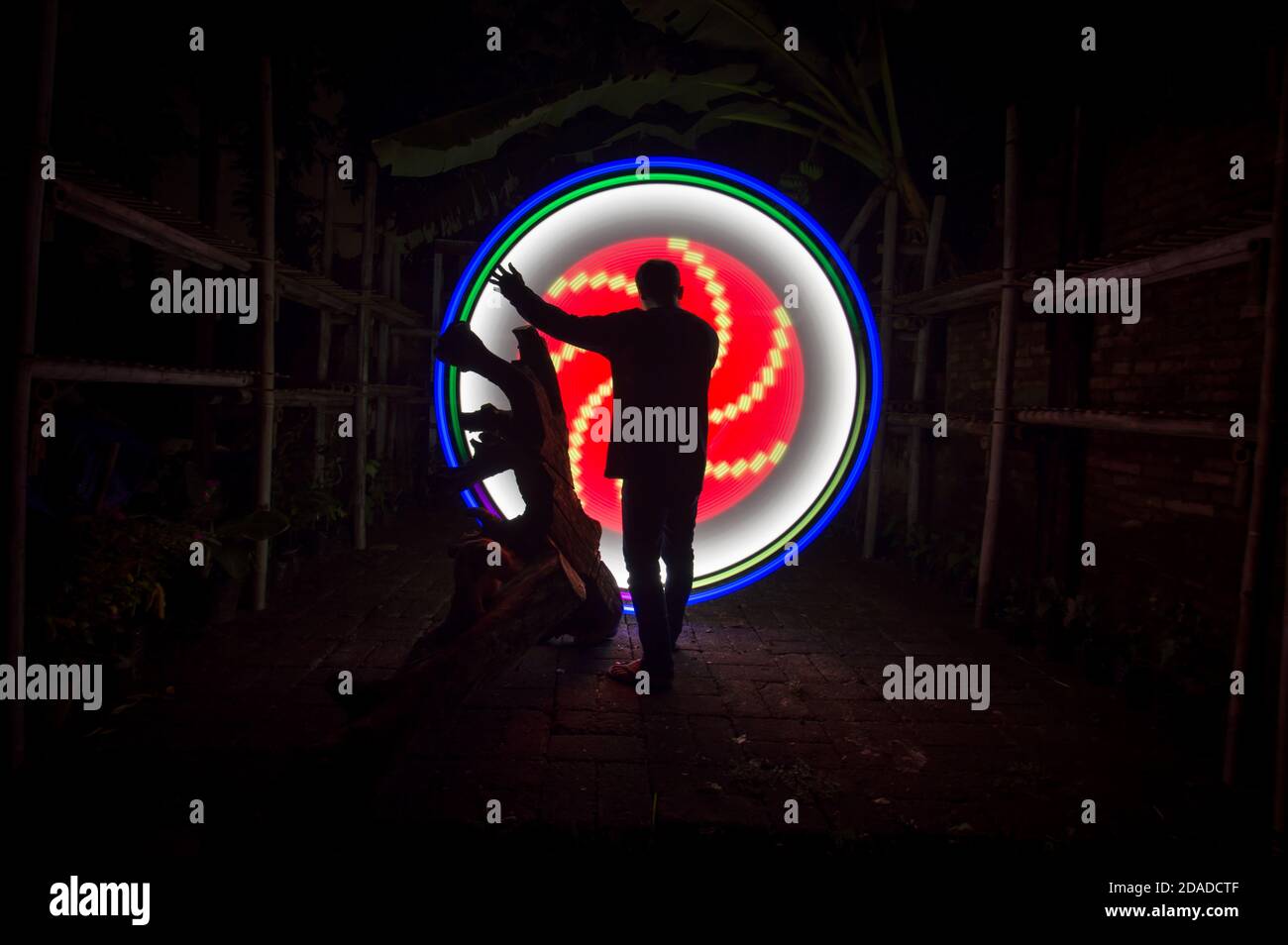 One person standing alone against beautiful red and white circle light ...