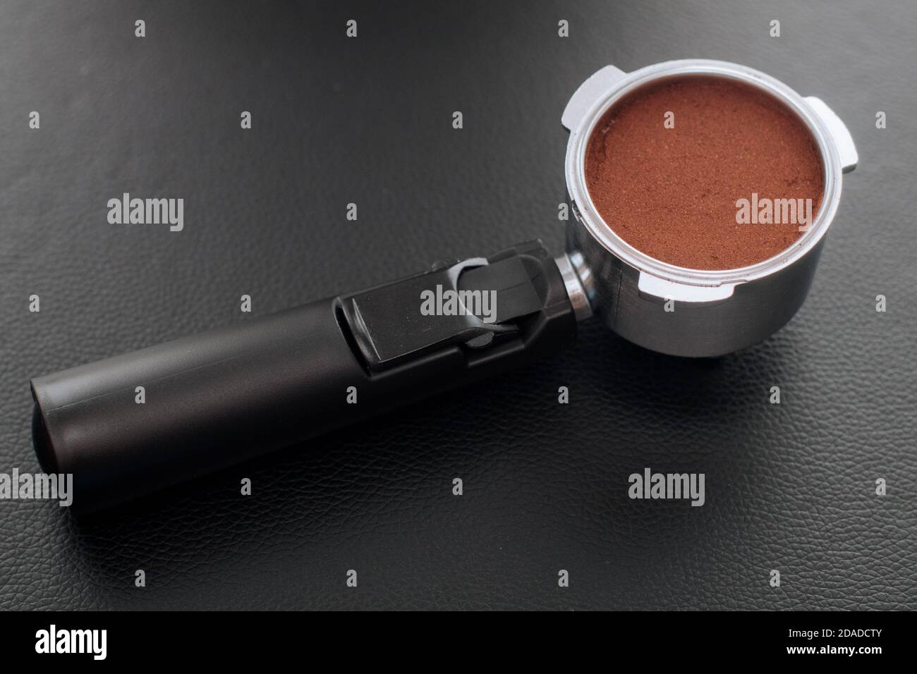 Metal holder from the coffee machine with ground coffee inside. Coffee ...