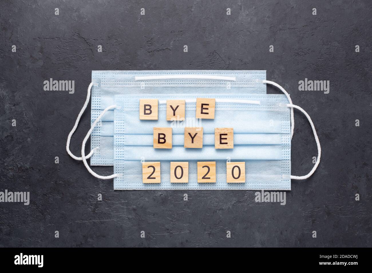 Text BYE BYE 2020 on medical mask on dark stone background - Image ...