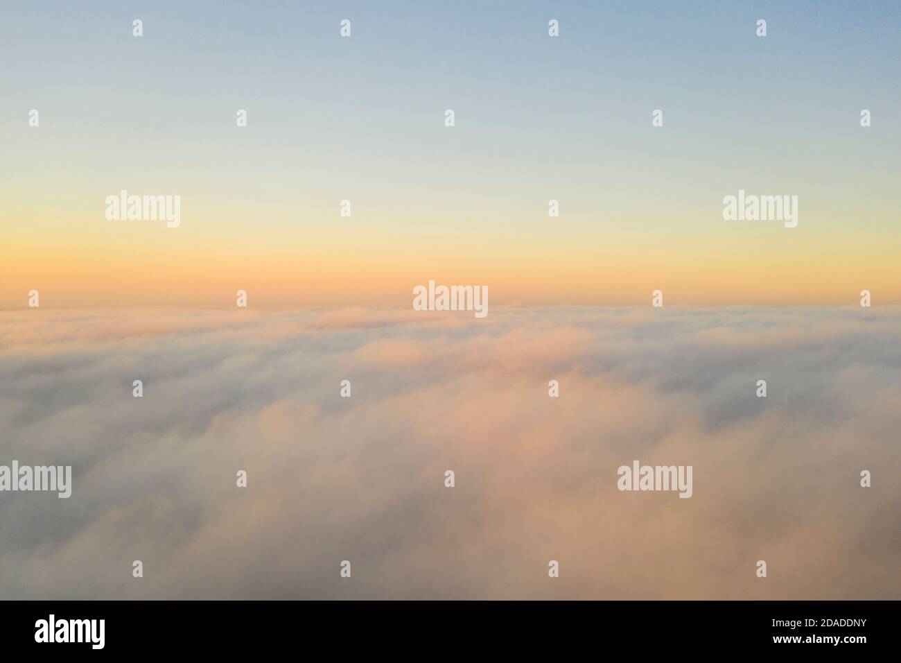 Aerial view gold sunrise over clouds in blue sky. Aerial top view ...