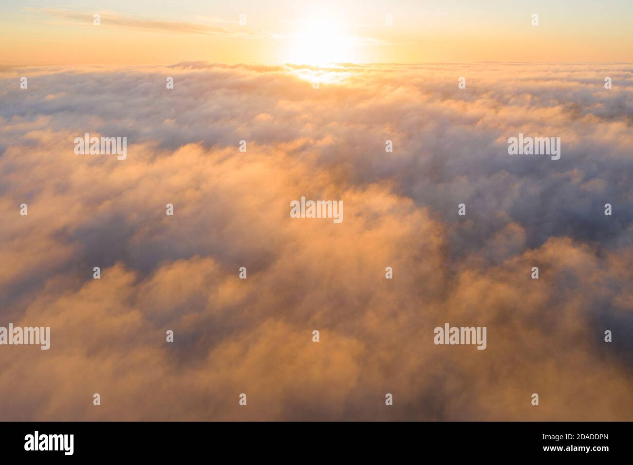 Aerial view gold sunrise over clouds in blue sky. Aerial top view ...