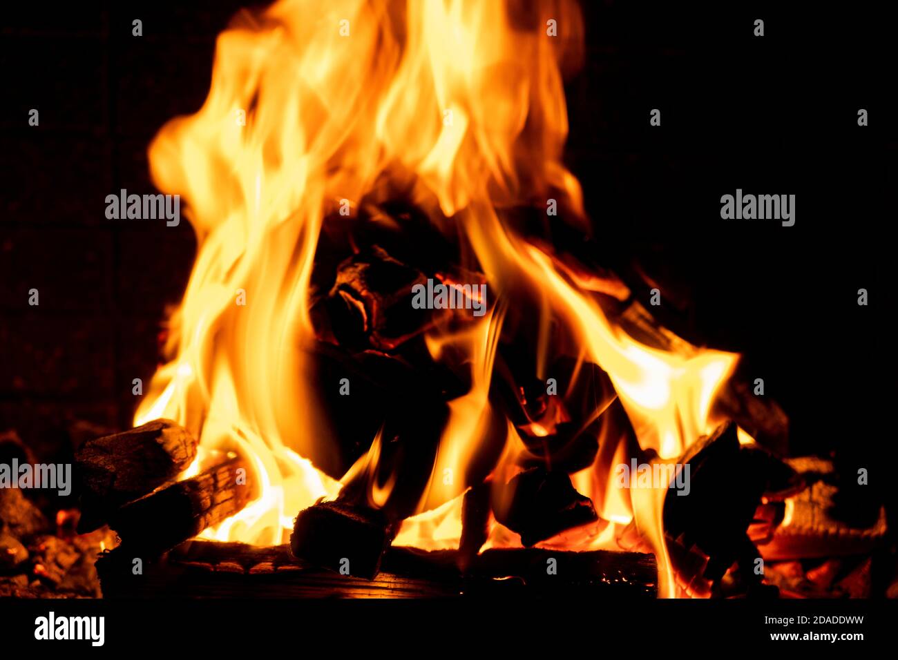 Hot fireplace full of wood. Real Flames from burning logs texture ...