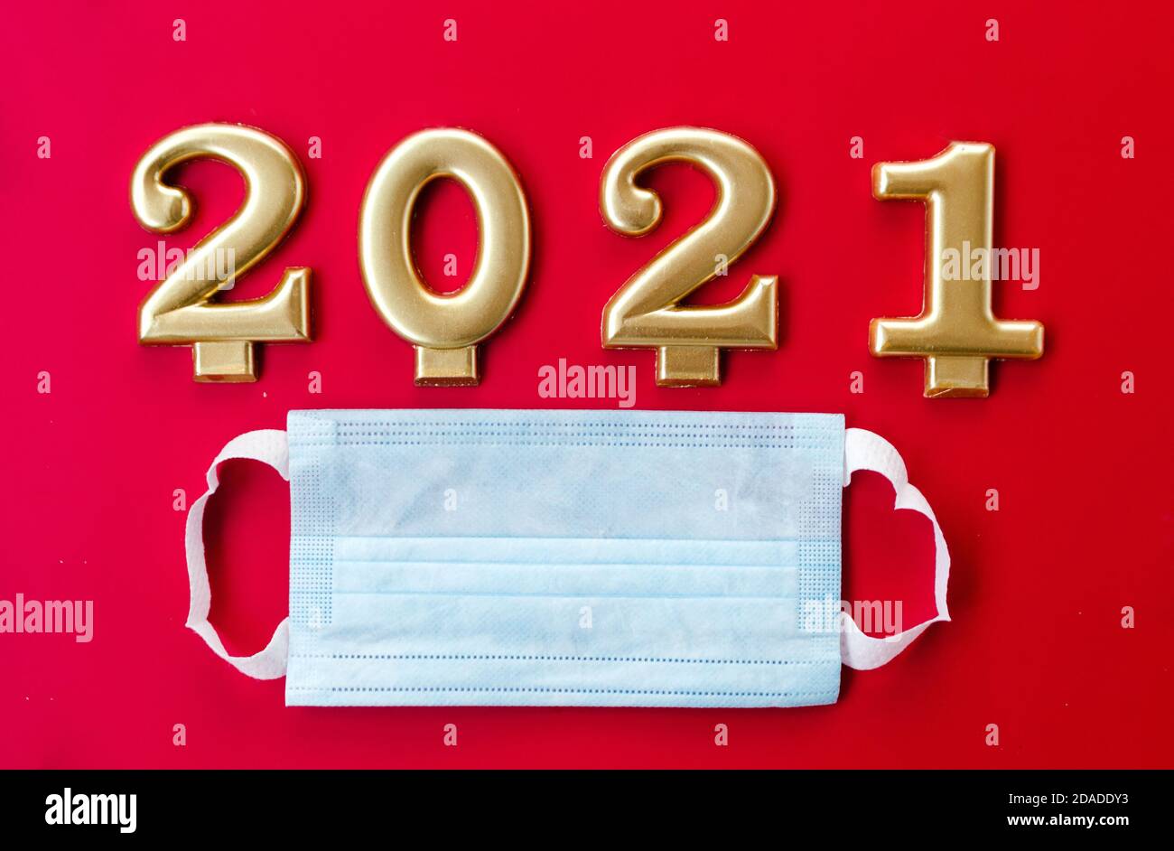 Blue medical mask on a red background and golden numbers 2021 as a ...