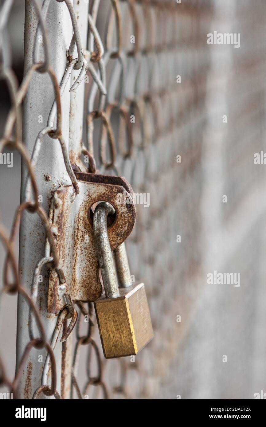 Padlock and fence grill rust texture background Stock Photo - Alamy