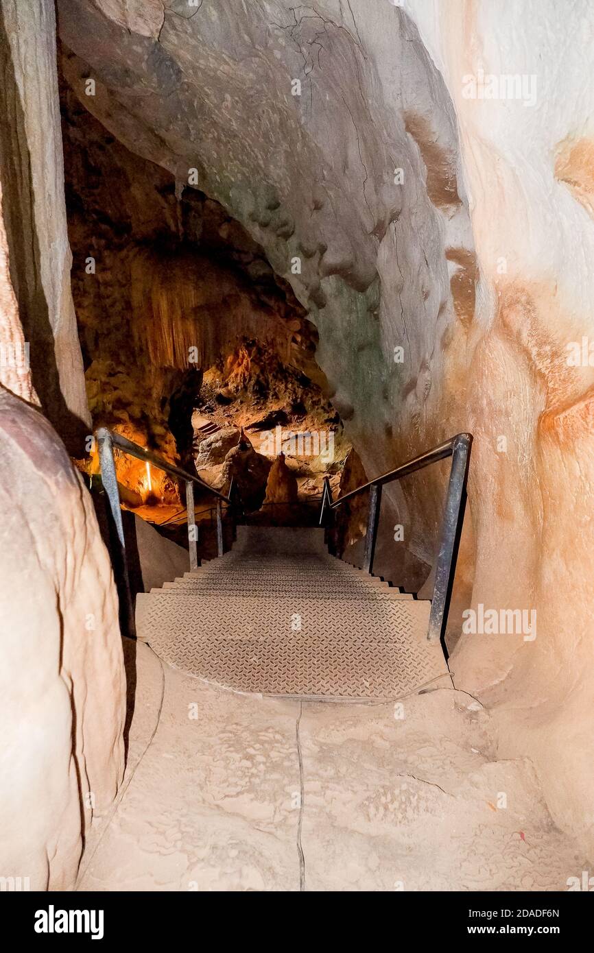 tourist cave .High arches of a huge stone cave with round holes at the ...