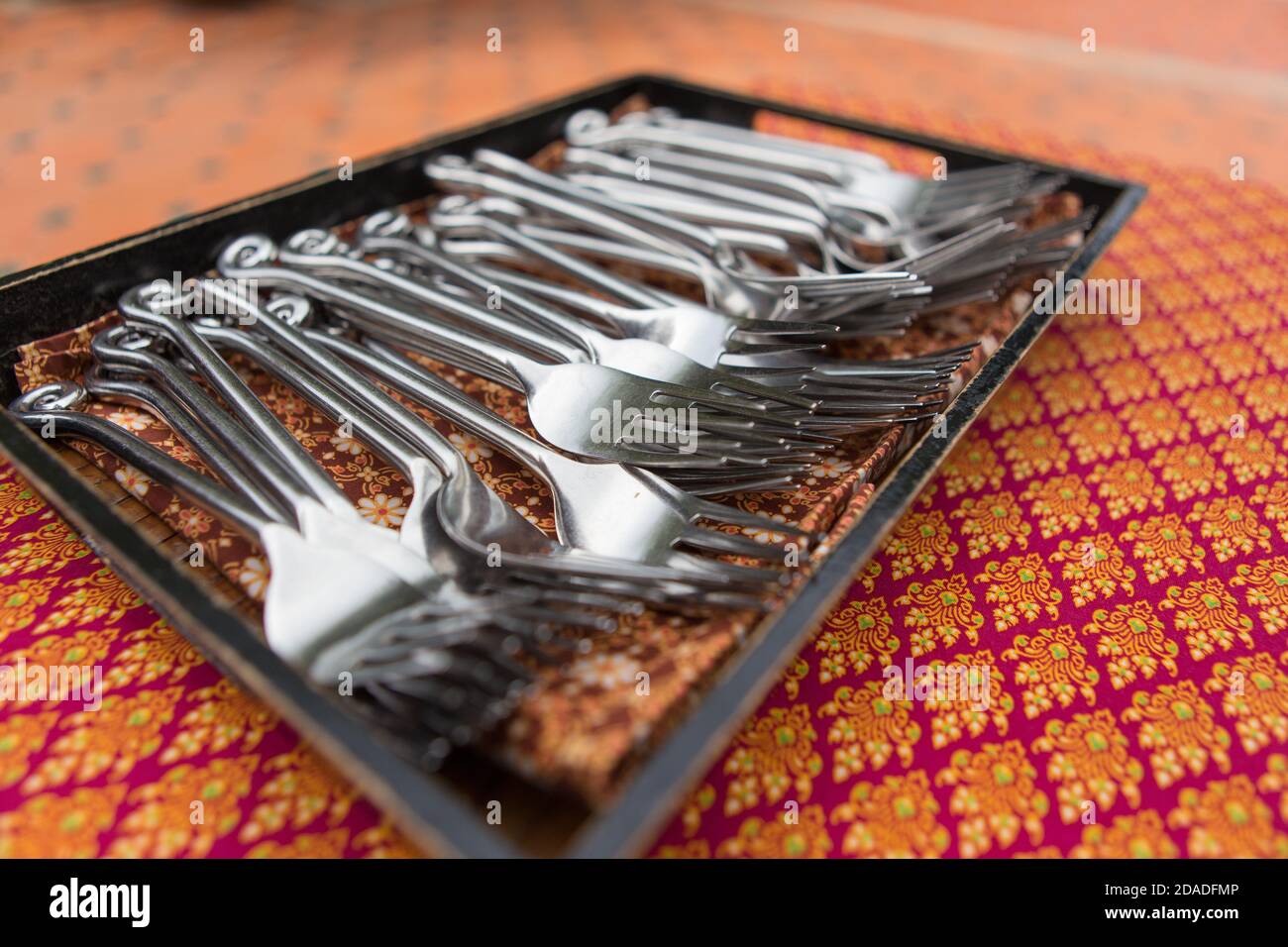 Stainless steel fork in wooden tray on woven cloth Stock Photo - Alamy