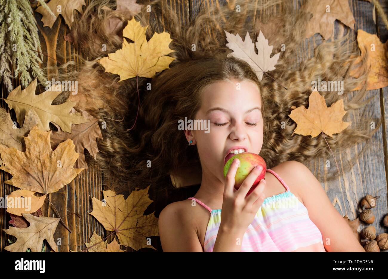 Munching an apple. Organic and natural food for kids health. Small girl ...