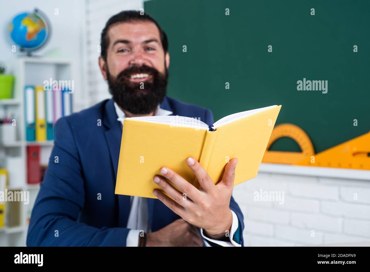 informal education. male student sit in school classroom while lesson ...