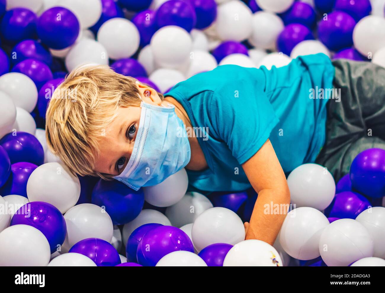 Cute blond child boy amusement playground entertainment indoor center ...