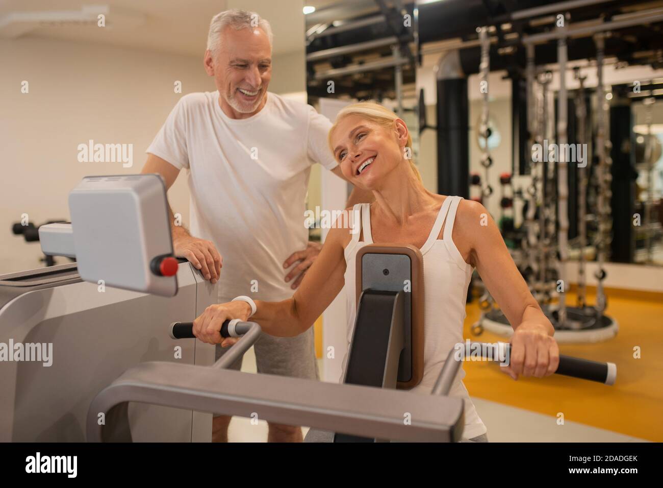 Mature couple exercising together in the gym and feeling great Stock ...