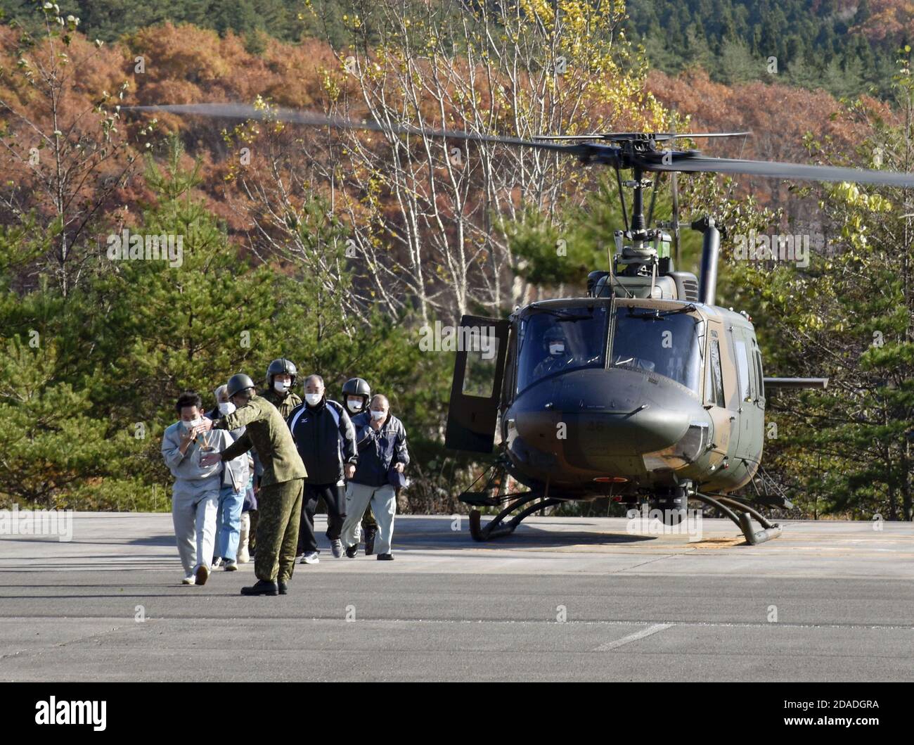 People take part in an emergency evacuation drill using a Japanese ...