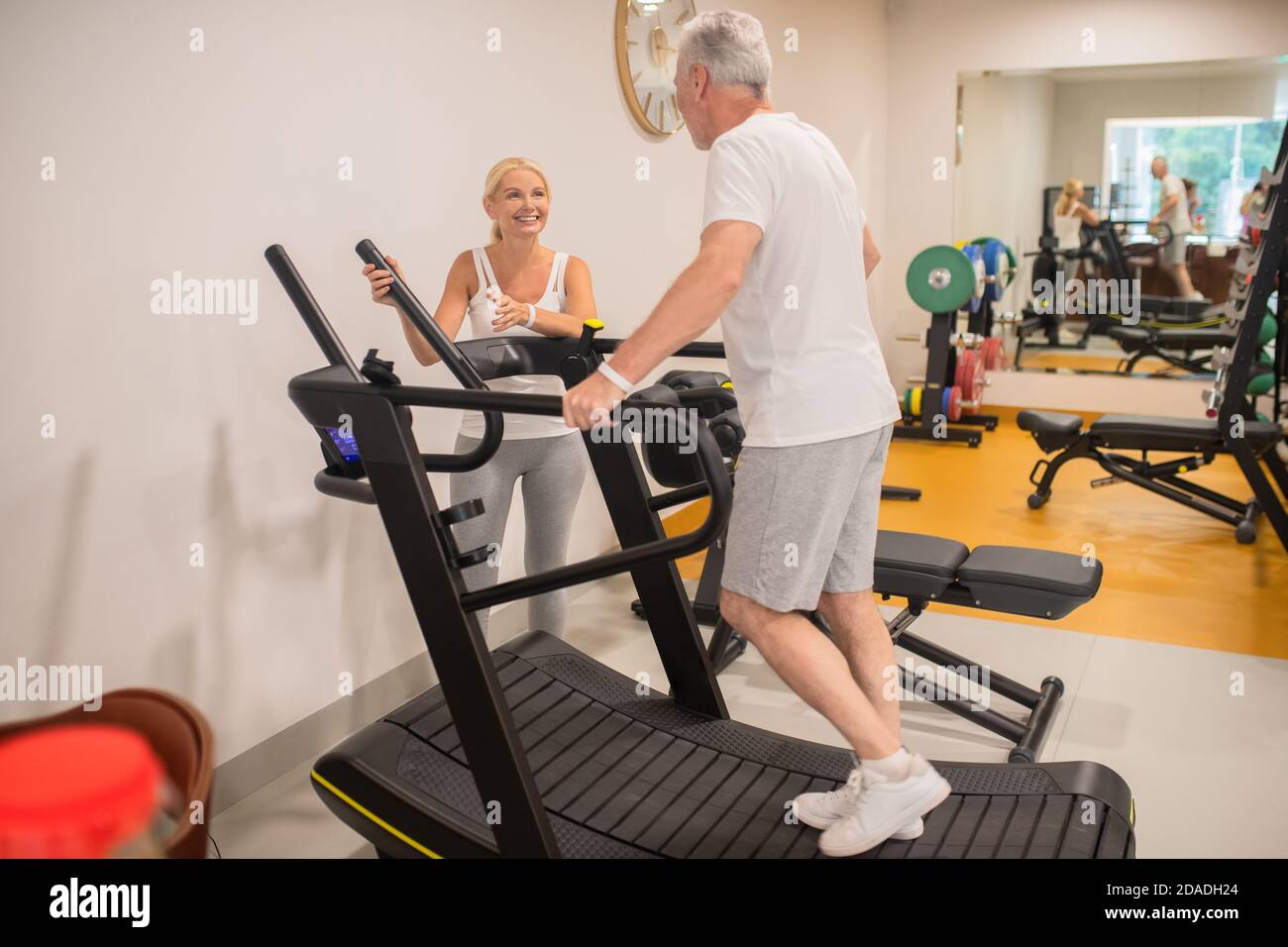 A man and a woman exercising on treadmills Stock Photo - Alamy
