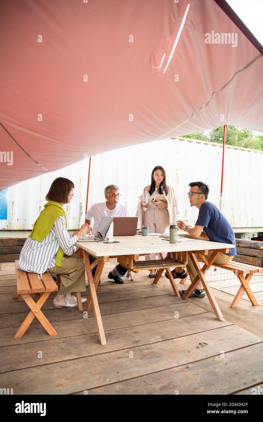 Men and Women Having a Meeting on an Outdoor Office as New Normal Work ...