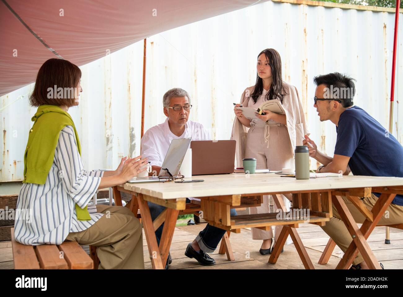 Men and Women Having a Meeting on an Outdoor Office as New Normal Work ...