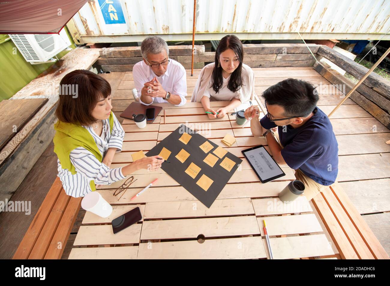 Men and Women Having a Meeting on an Outdoor Office as New Normal Work ...
