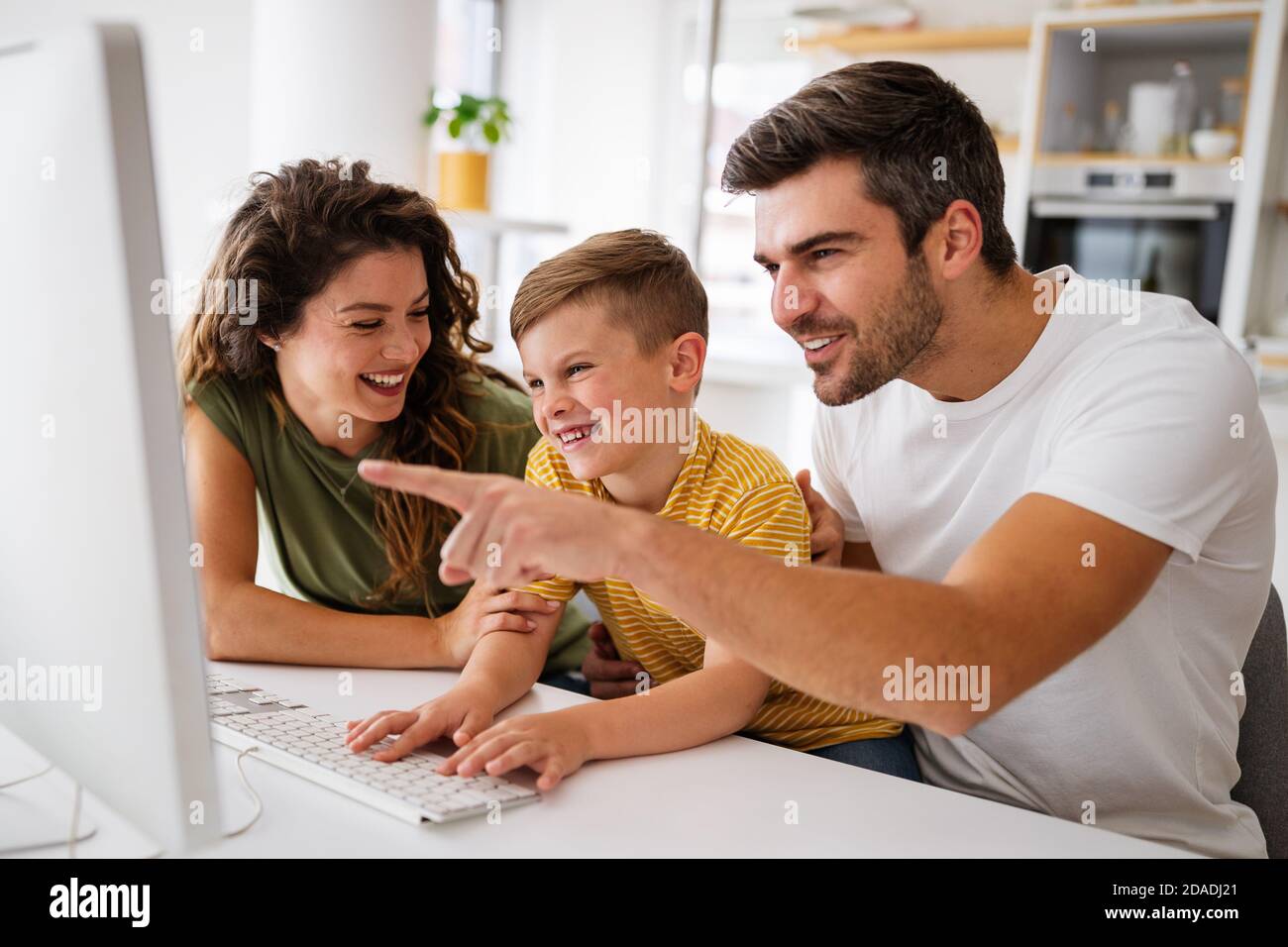 Happy family using technology devices together at home Stock Photo - Alamy
