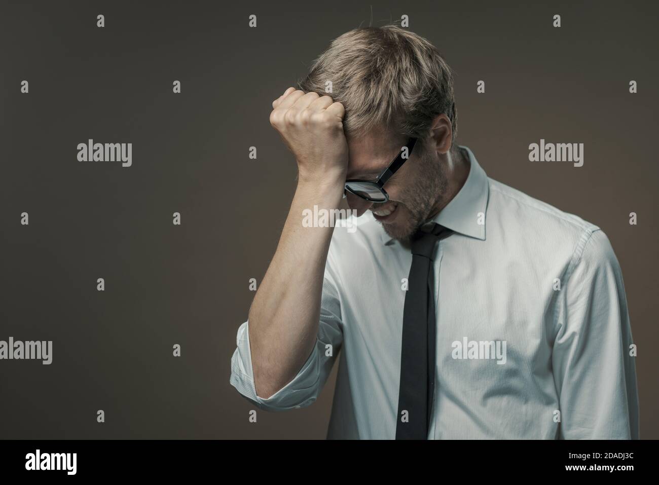 Stressed frustrated businessman making a facepalm gesture, he feels ...