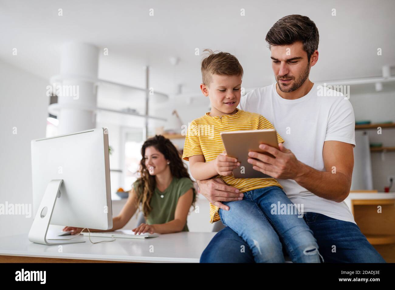 Happy family using technology devices together at home Stock Photo - Alamy
