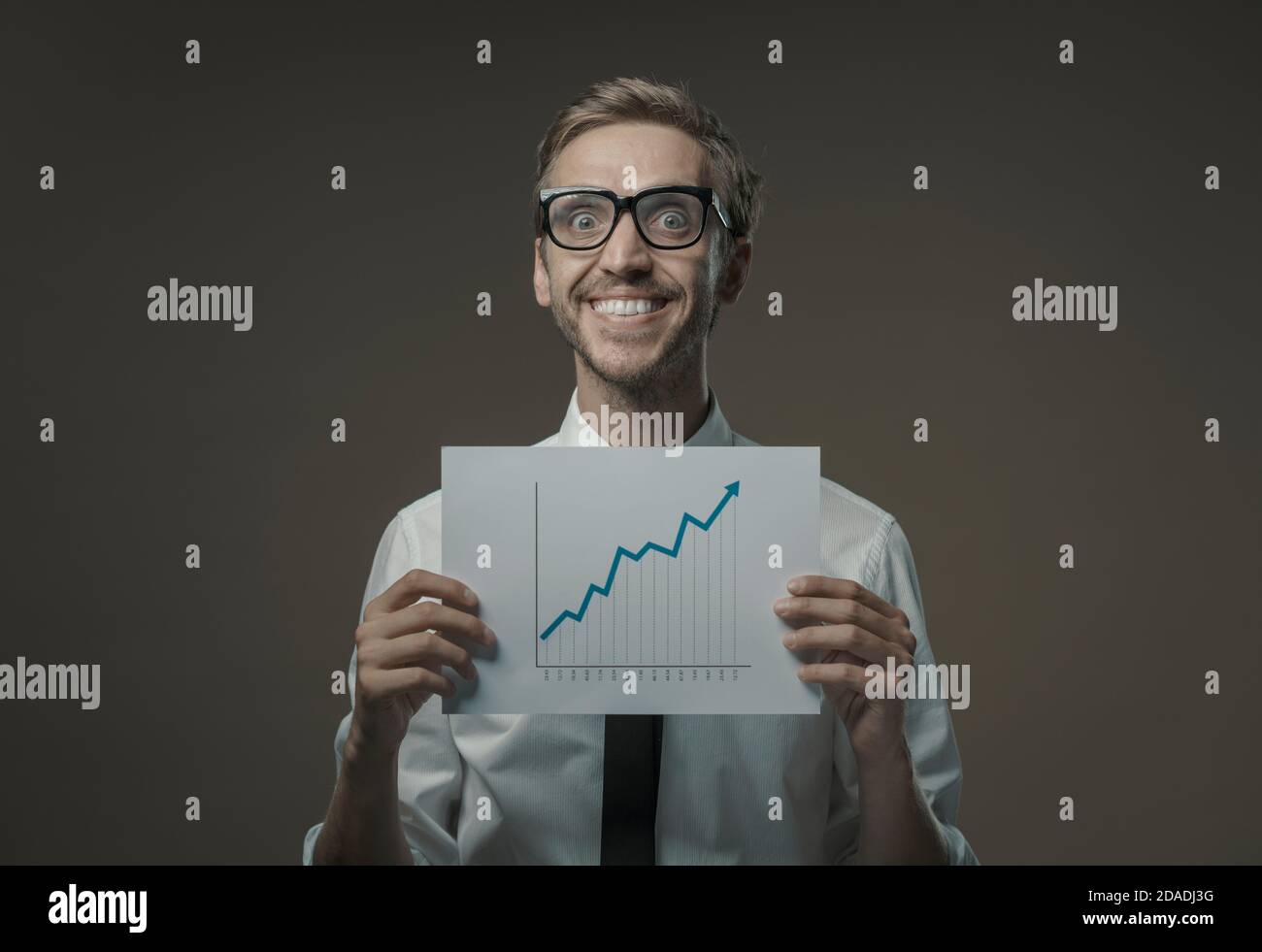 Happy businessman holding a positive financial chart with arrow going ...
