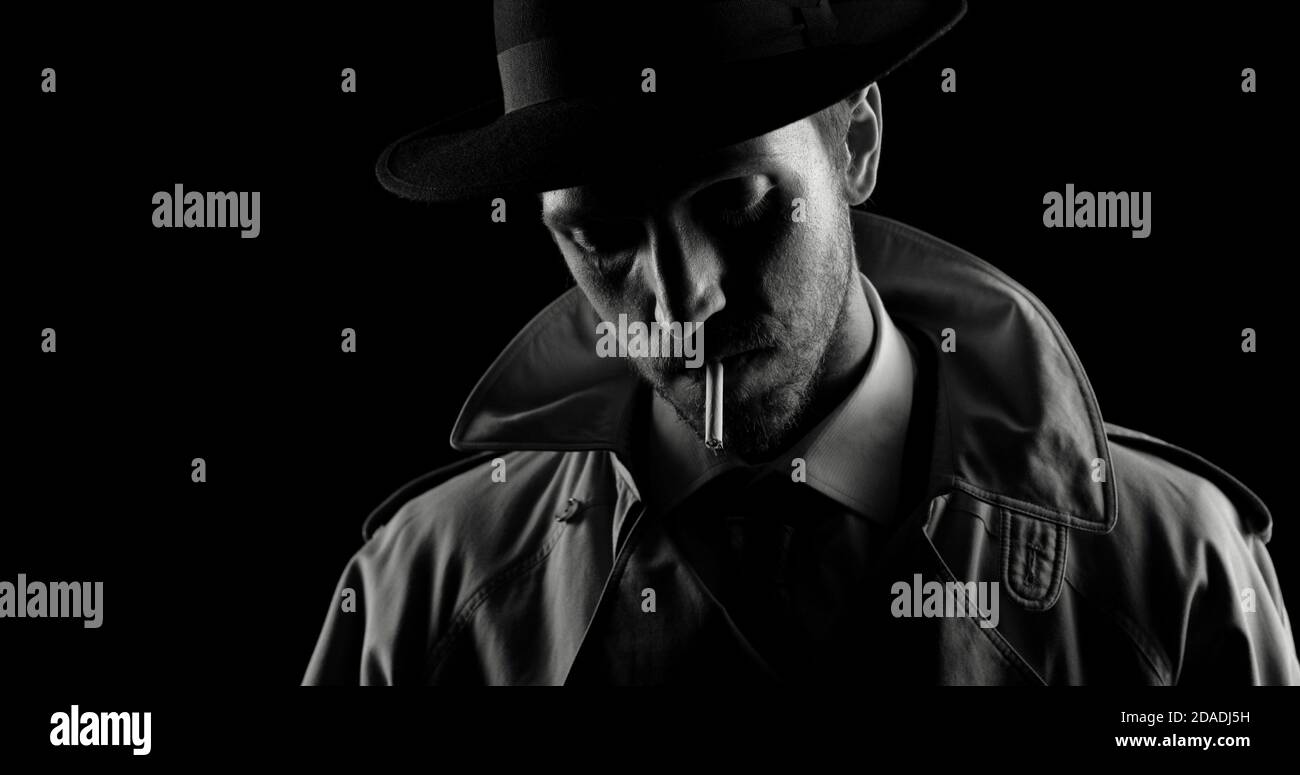 Noir film detective posing in the dark, he is smoking a cigarette Stock ...