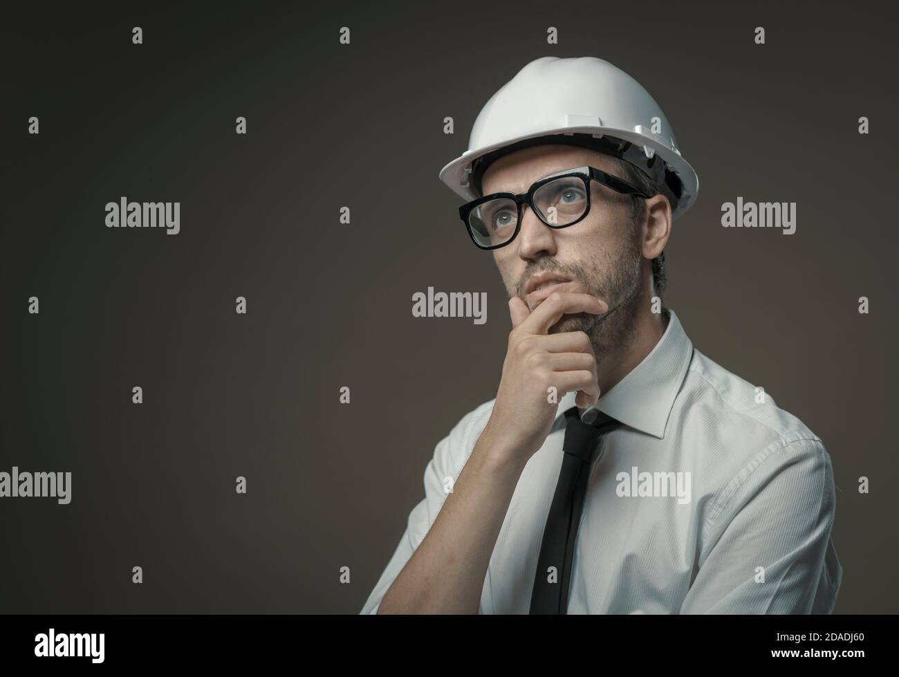 Construction engineer thinking with hand on chin: problem solving and ...