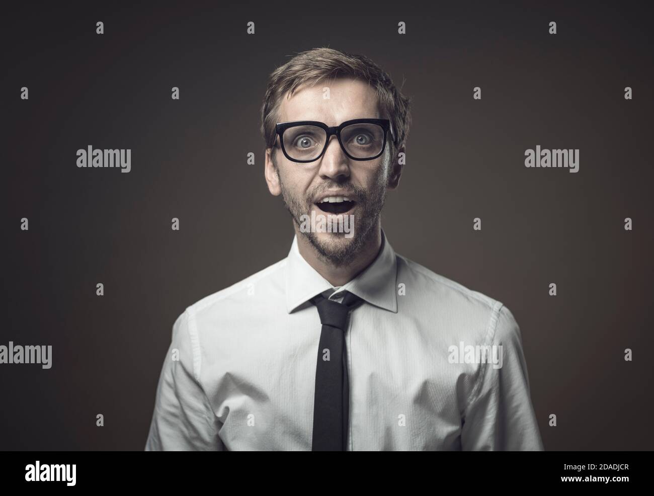 Surprised man staring at camera with amazement, he is excited and ...