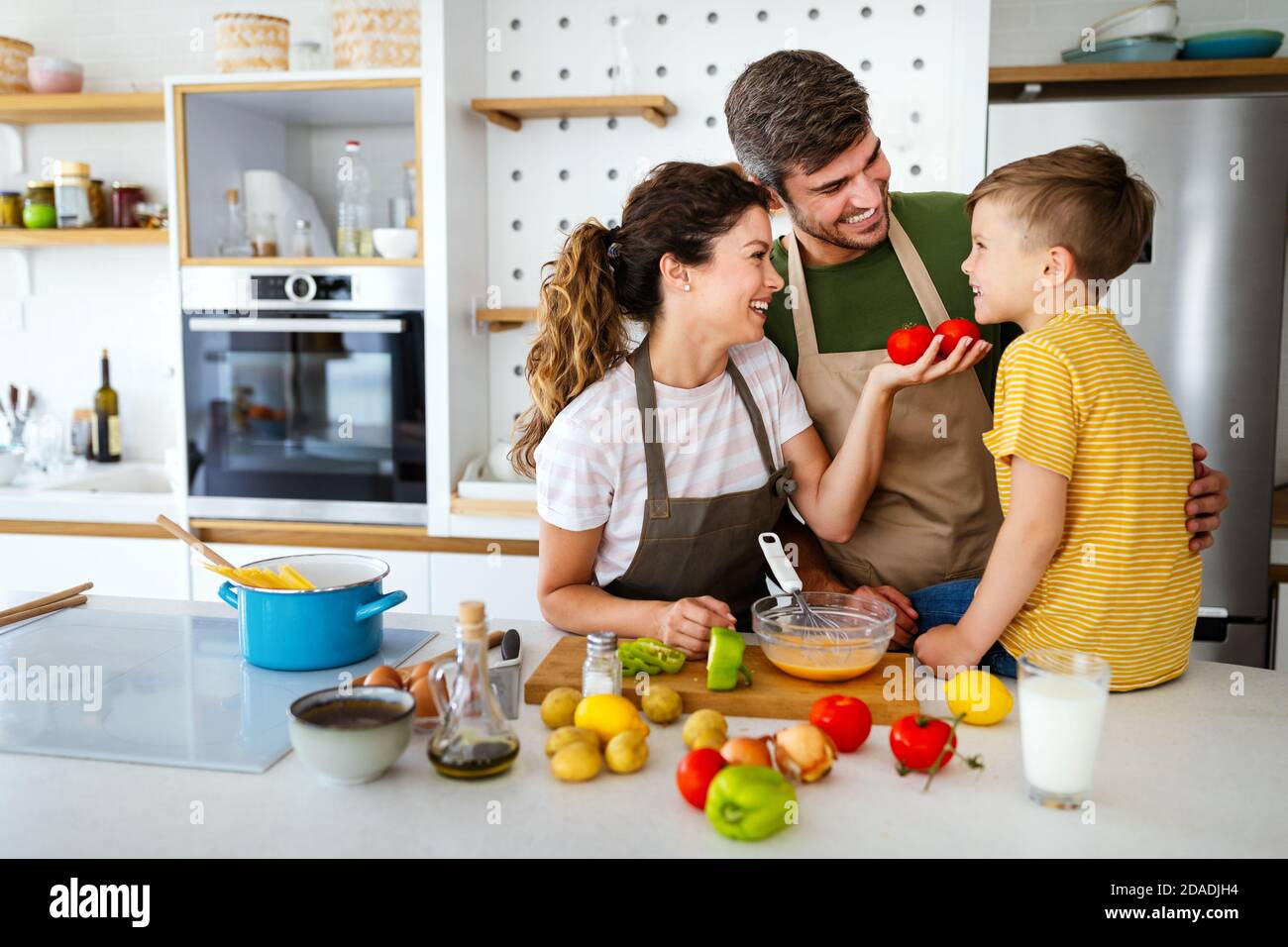 Happy family in the kitchen having fun and cooking together Stock Photo ...