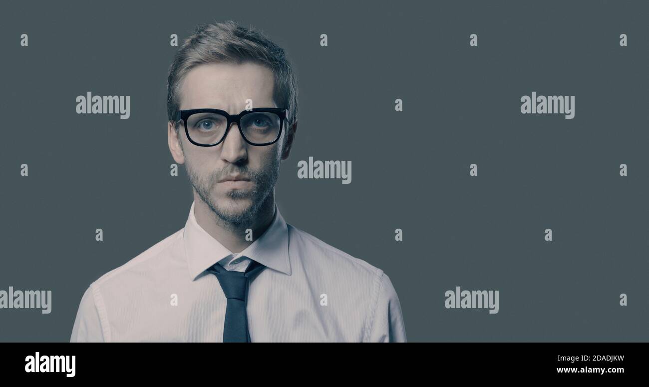 Businessman staring at camera with confident expression, he is cool and ...