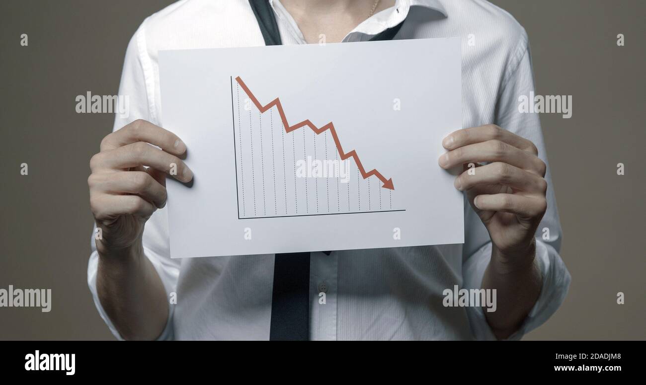 Businessman holding a negative financial chart, bankruptcy and ...