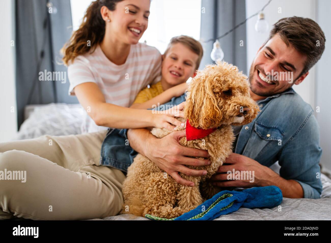 Happy family having fun time, playing together at home with dog Stock ...